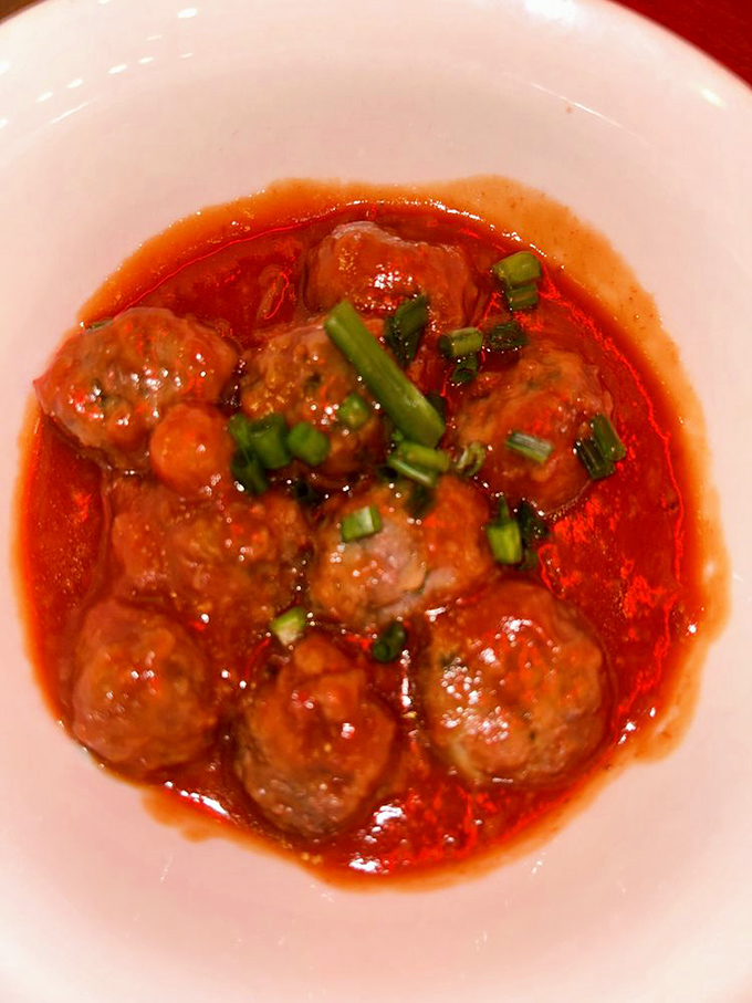 Vermont venison meatballs swim in vibrant tomato sauce &ndash; a dish that transforms local hunting tradition into sophisticated comfort food worth savoring slowly.