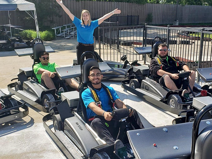 Ready, set, pose! The pre-race excitement is palpable as these go-kart enthusiasts prepare to battle for family bragging rights.