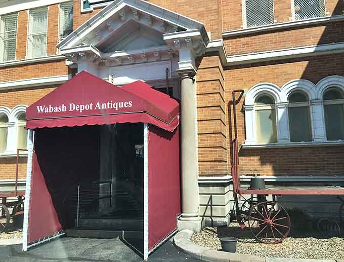 That red awning beckons treasure hunters inside like a portal to the past, promising adventures in every aisle and surprises around every corner.