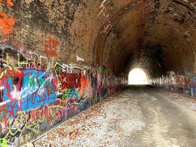 Graffiti artists have made their mark through decades, adding colorful layers to the tunnel's storied walls.