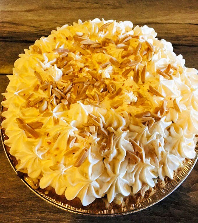 Banana cream pie with toasted coconut and perfect swirls of whipped cream looks almost too beautiful to eat. Almost.