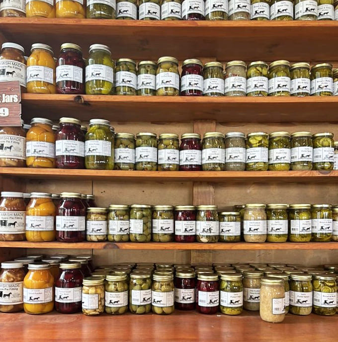 Shelves lined with homemade preserves and pickled goods showcase the farm's commitment to capturing flavors in jars for year-round enjoyment.