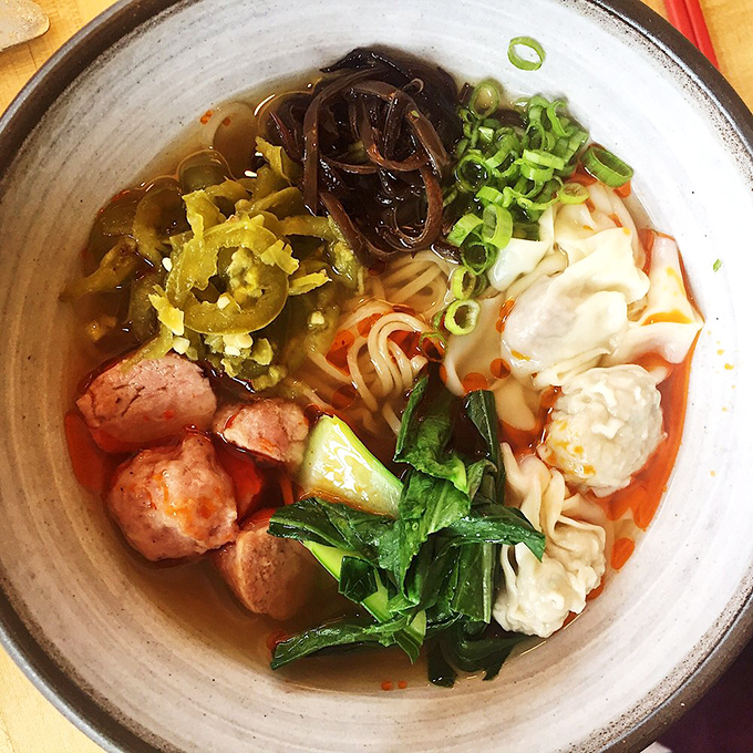 Delicate parcels of flavor float in crystal-clear broth alongside vibrant greens &ndash; proof that sometimes the simplest dishes require the most skill.