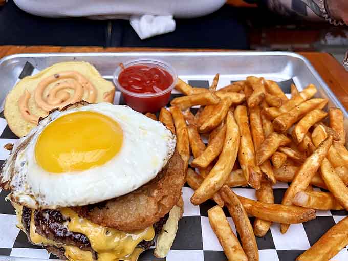 The Yo Mama Burger stacks a fried egg on top like a crown, because apparently someone's mama knew exactly what burgers needed.