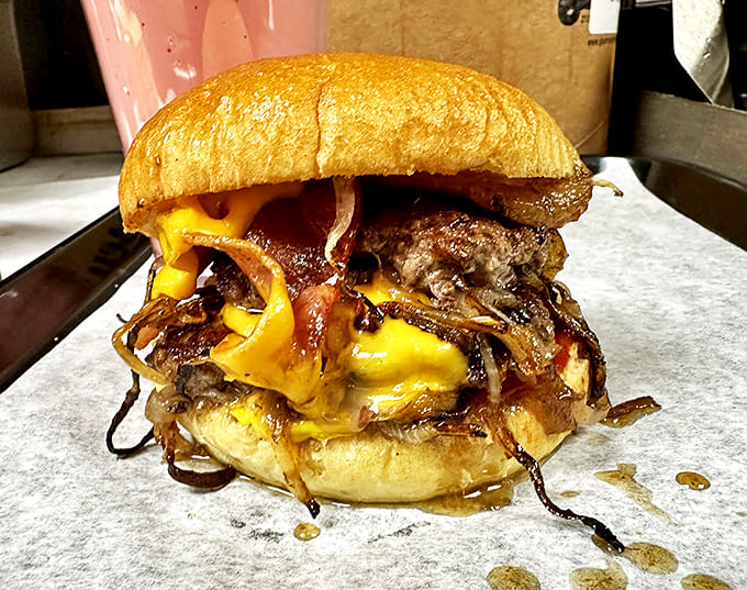 Melted cheese cascades over double beef patties and bacon in this tower of flavor that challenges even the heartiest appetites.