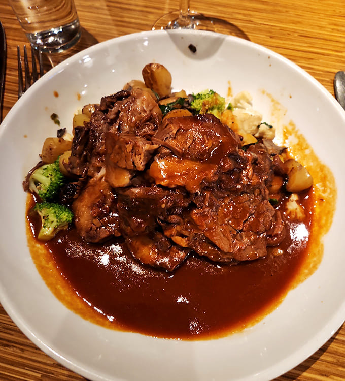 Braised short ribs that surrender to your fork before you even touch them. That sauce? It's been simmering since yesterday, collecting flavor like precious memories.