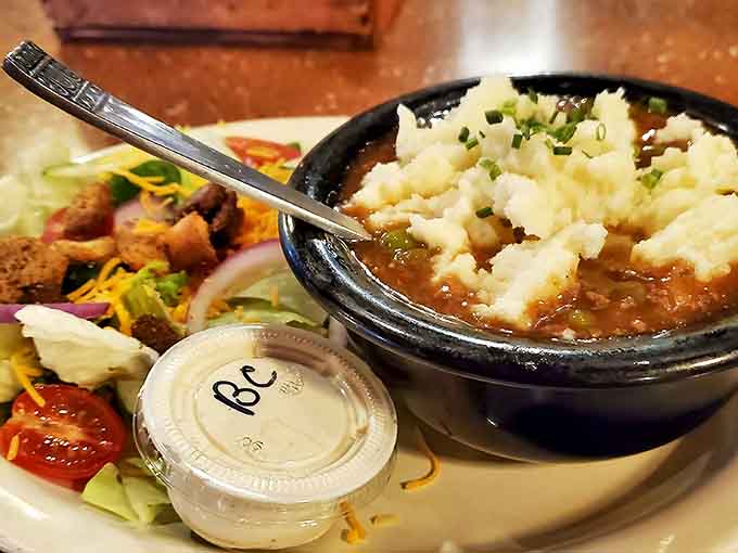Steaming shepherd's pie alongside a fresh garden salad offers the perfect balance of rich comfort and crisp freshness.