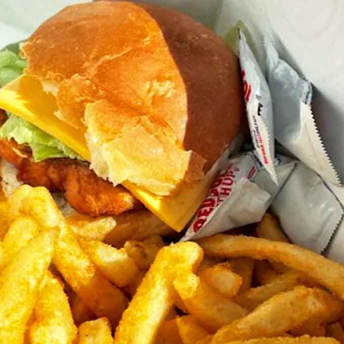 The fish sandwich &ndash; architectural perfection with that golden-fried whitefish peeking out from under melty cheese on a pillowy bun.