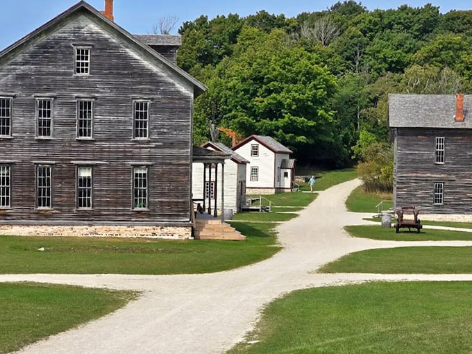 Historic structures frame a path to the water, creating a perfect postcard of 19th-century industrial America frozen in time.