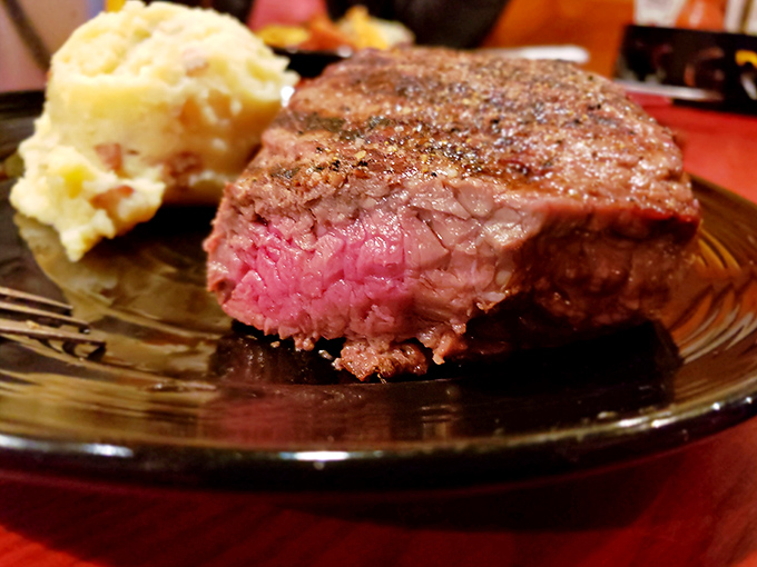 That perfect medium-rare pink center reveals the kitchen's precision. Each bite delivers the beef flavor that steak aficionados travel miles to experience.