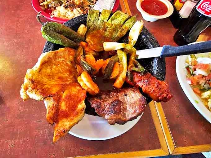 Molcajete: A volcanic rock bowl bubbling with meaty treasures and vegetables. It's dinner and a show that continues cooking right at your table!