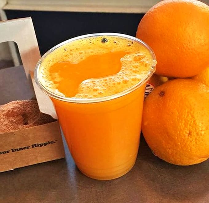 Fresh-squeezed orange juice provides a tangy counterpoint to sweet treats, served alongside a box promising to "Feed Your Inner Hippie."