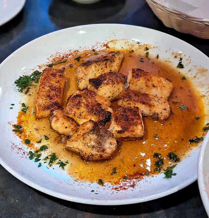 Golden-seared fish swimming in buttery sauce &ndash; simple ingredients transformed into something magical through technique and respect for tradition.
