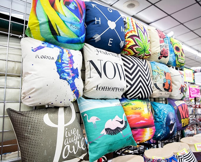 Florida-themed pillows that let you bring vacation vibes home, because nothing says "sophisticated decor" like a flamingo telling you to "Live, Laugh, Love."