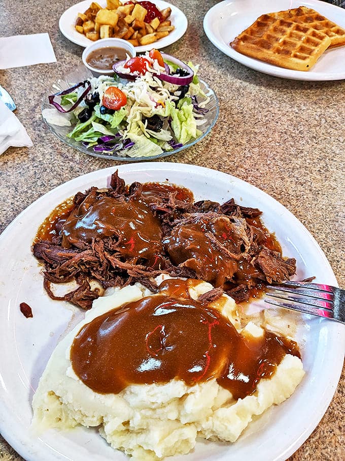 Pot roast that falls apart at the mere suggestion of a fork, swimming in gravy that deserves its own fan club.
