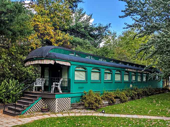 The forest-green Palace Car from 1909 sits peacefully on the property, looking like it's enjoying a well-deserved retirement from its dining car days.