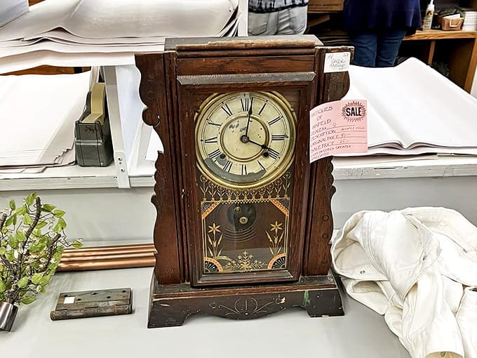 A stately wooden shelf clock stands frozen at a moment in time, its ornate carvings and aged face bearing witness to decades of passing hours.