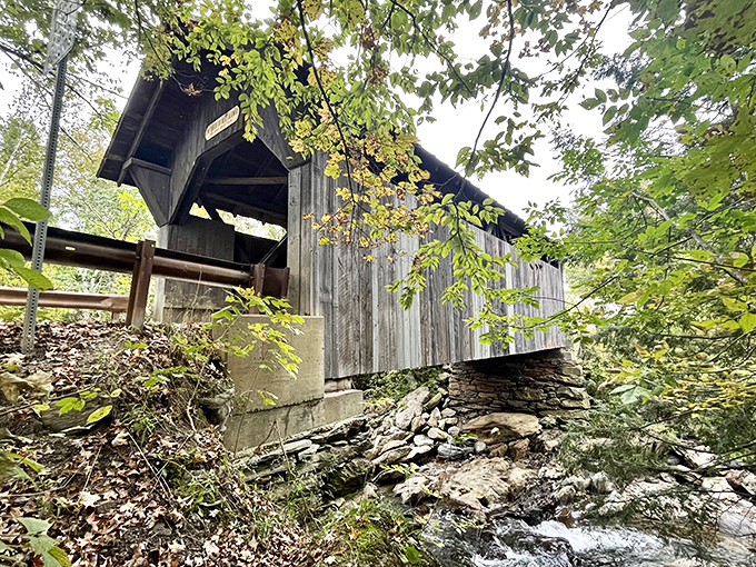 The weathered side view reveals the bridge's 19th-century craftsmanship, its wooden bones having witnessed nearly two centuries of travelers&mdash;and perhaps one tragic end.
