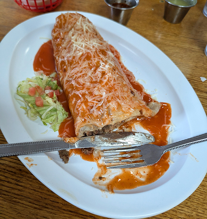 Smothered in vibrant red sauce and melted cheese, this burrito transforms from mere meal to Mexican comfort food at its finest.