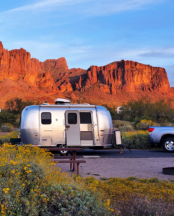 An Airstream gleams in the golden hour light, the perfect basecamp for desert explorers seeking comfort after a day of adventure.