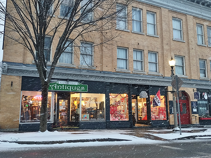 Even in winter's embrace, the warm glow from Main Street Antiques' windows promises cozy treasure hunting away from Vermont's chill.
