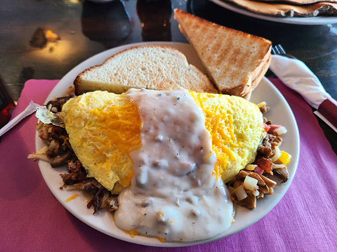 Breakfast of champions! This hearty omelet smothered in country gravy would make any farmer proud – comfort food at its finest.