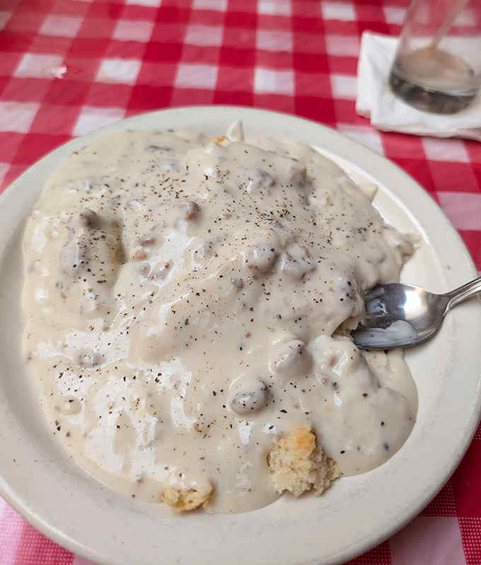 Cloud-like biscuits swimming in peppery sausage gravy &ndash; this isn't just breakfast, it's a religious experience worth the pilgrimage.