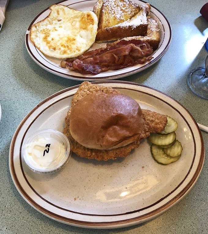 The breakfast-lunch dilemma solved! Golden French toast and a tenderloin sandwich that's practically wearing the plate as a hat.