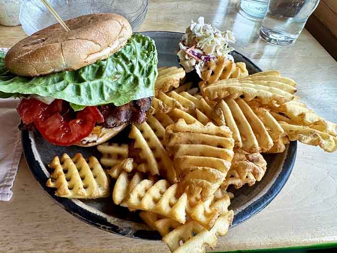 This burger comes stacked high with a mountain of fries, proving landlubbers aren't forgotten at this lakeside spot.