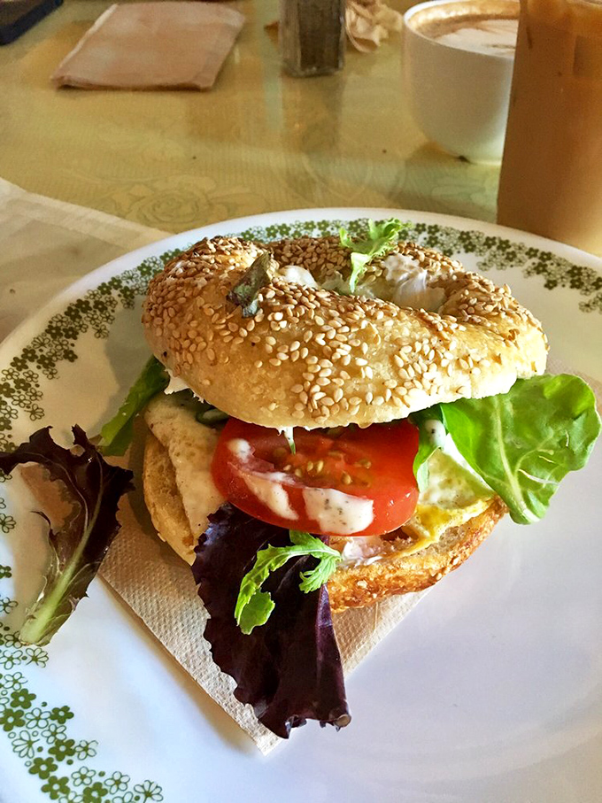 A sesame bagel sandwich showcases the ideal ratio of fillings to bread &ndash; each component playing its part in perfect harmony.