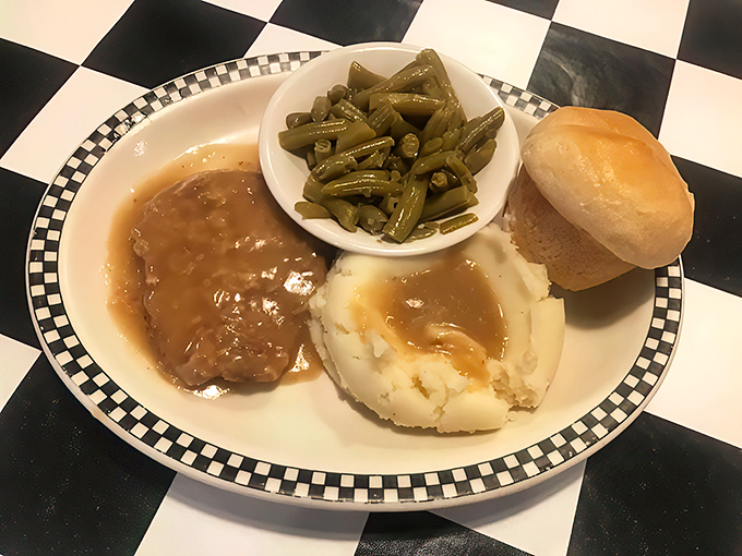 Comfort food alert! This baked steak, smothered in gravy, is like a warm blanket for your stomach on a chilly day.