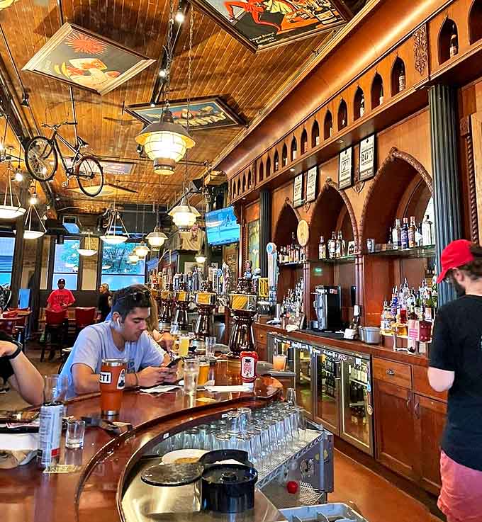 The curved wooden bar invites conversation while showcasing an impressive array of taps that promise liquid happiness.