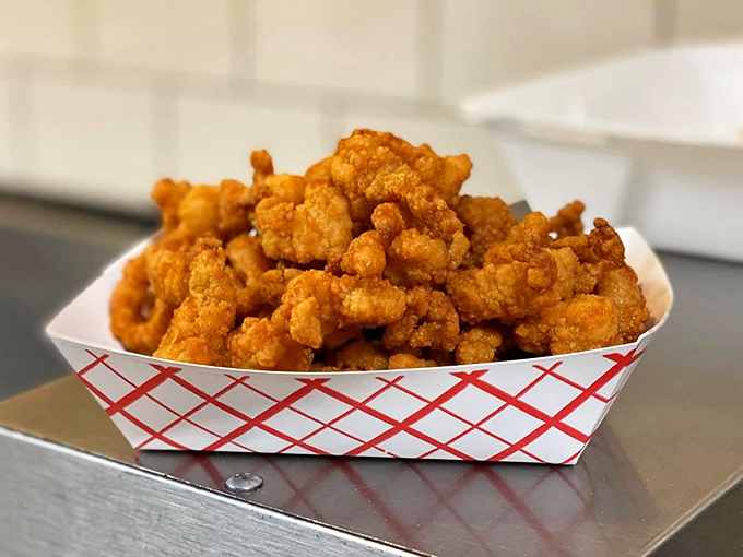 Golden-fried clam strips with a delicate crunch giving way to briny tenderness &ndash; the ocean's treasures transformed through the magic of proper battering.