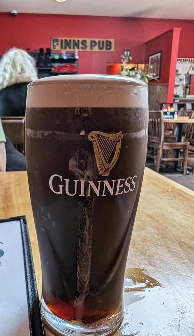 The perfect pint of Guinness takes patience to pour correctly &ndash; note the creamy head and dark body, a visual promise of flavor. 