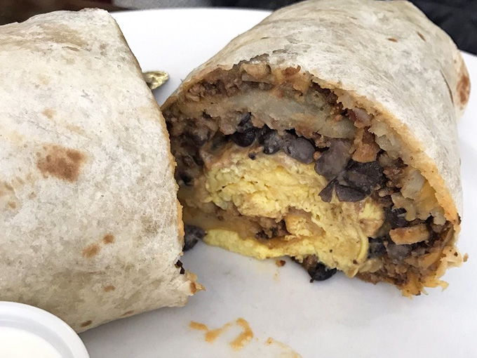 That cross-section reveals the beautiful architecture within: eggs, beans, chorizo, cheese, and hash browns in perfect harmony.