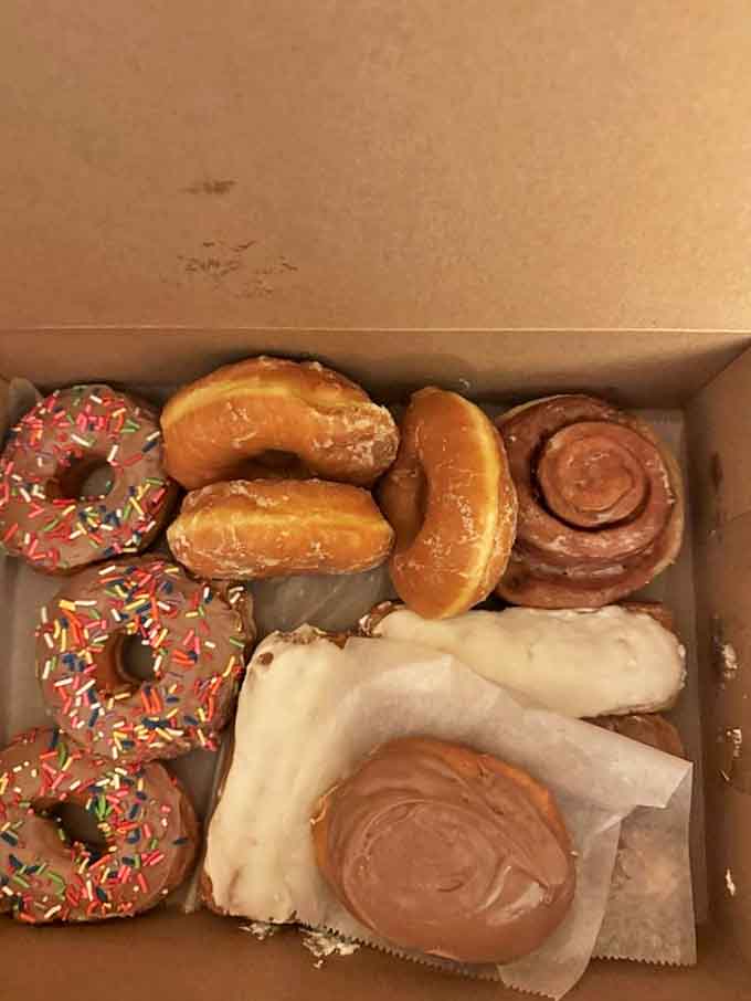Box of donuts: The ultimate democracy &ndash; chocolate-glazed neighbors living harmoniously beside cinnamon twists. Opening this box releases endorphins science hasn't yet measured.