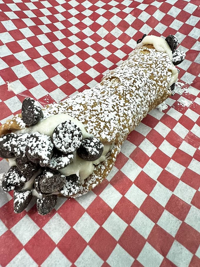 This isn't just dessert &ndash; it's a sweet revelation where crispy shell meets creamy filling in a powdered-sugar dusted masterpiece.