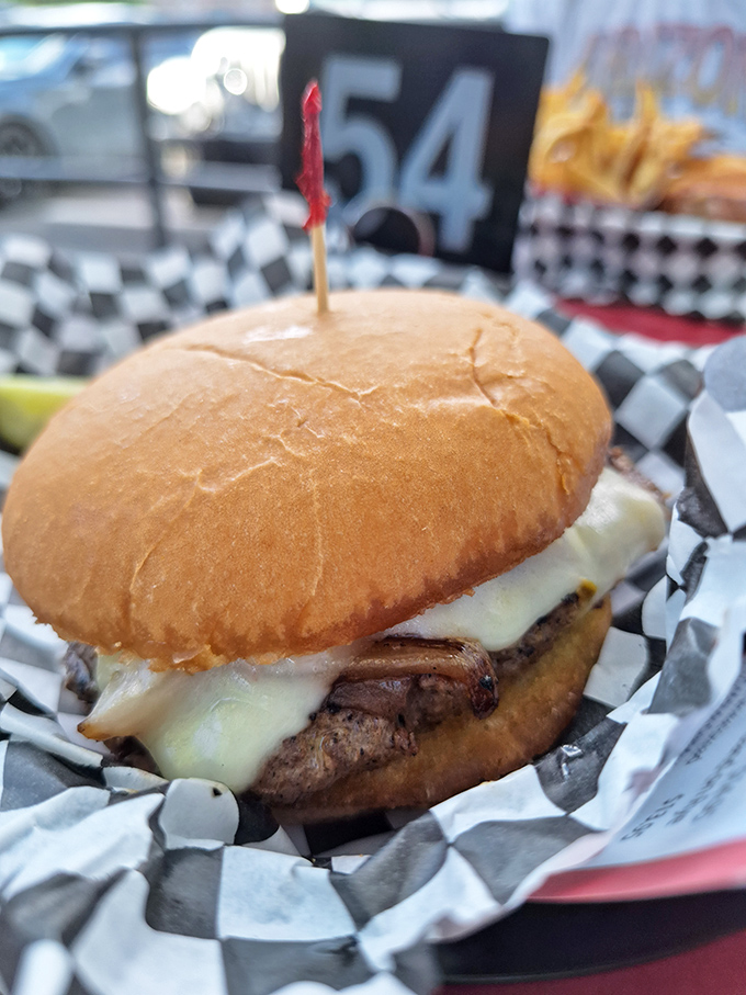 The burger that launched a thousand road trips – perfectly proportioned, hand-formed, and cooked with the kind of attention most places reserve for filet mignon.