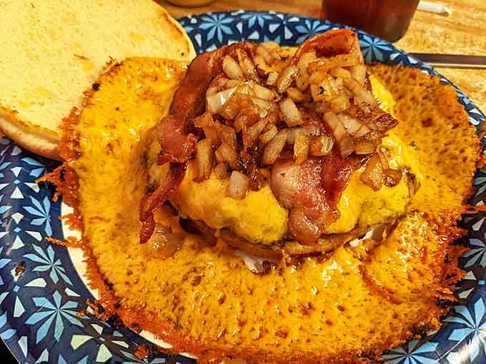 Bacon stands at attention like edible soldiers guarding a fortress of melted cheese and perfectly cooked beef.