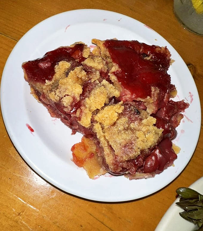 Cherry pie oozing with fruit and topped with golden crumble, making every other dessert look like it's not even trying.