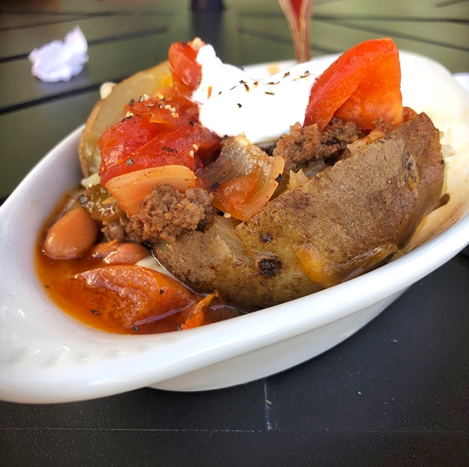 This loaded baked potato transforms the humble spud into a meal worthy of celebration, topped with chili and all the fixings.