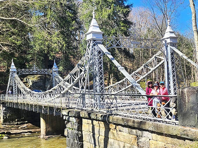 Visitors pause to appreciate the bridge's timeless charm, creating new memories at a landmark that has witnessed over a century of moments.