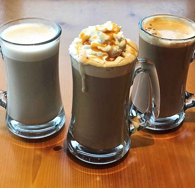 Three mugs of happiness, each topped with enough whipped cream to make your inner child squeal with delight.
