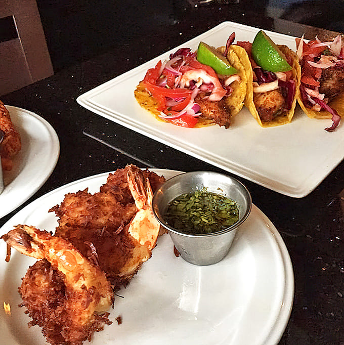 Coconut shrimp that crunch like autumn leaves, alongside fish tacos that make you question why you'd ever order anything else.