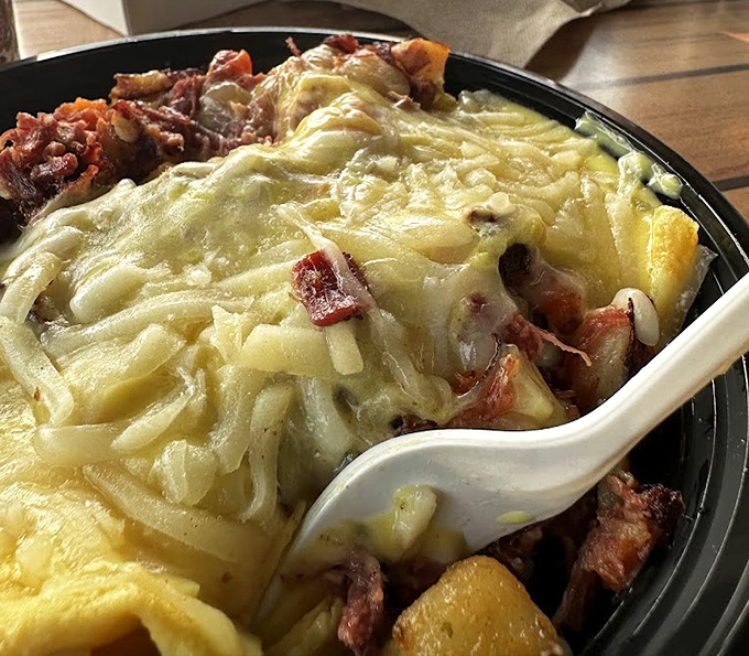 Layer upon layer of breakfast joy – an omelet foundation topped with that famous hash and blanketed in melted cheese.