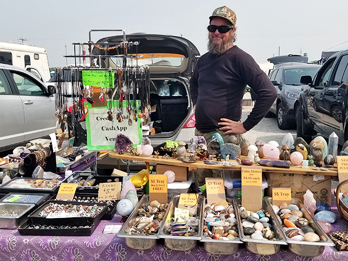 A vendor proudly displays his collection of crystals and stones – nature's jewelry box opened for those seeking beauty or metaphysical properties.
