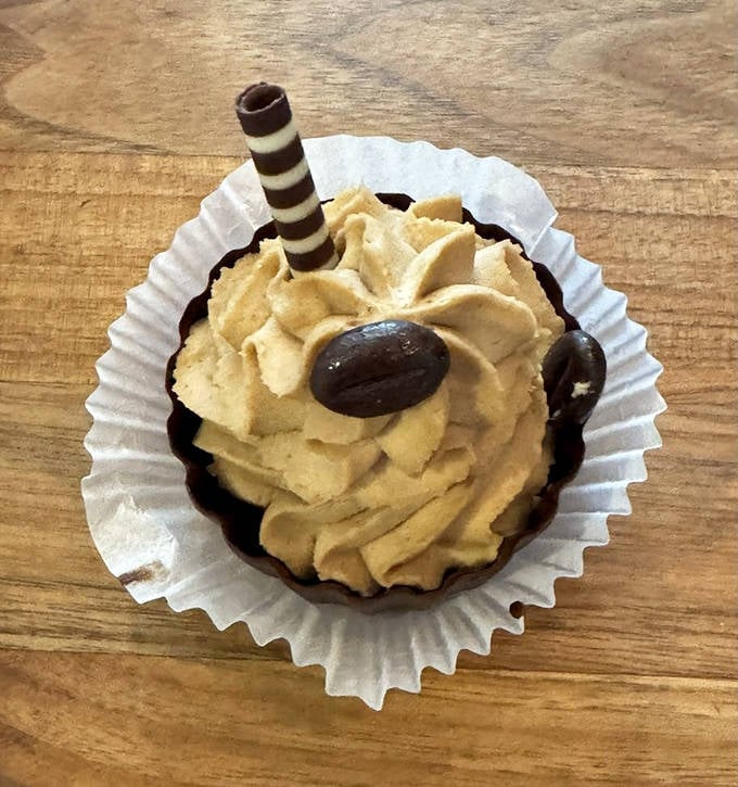 This isn't just a cupcake; it's a tiny architectural marvel with coffee-infused frosting and chocolate accents.