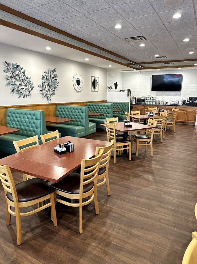 Mint-green booths and natural light create the kind of space where breakfast conversations flow as smoothly as coffee.