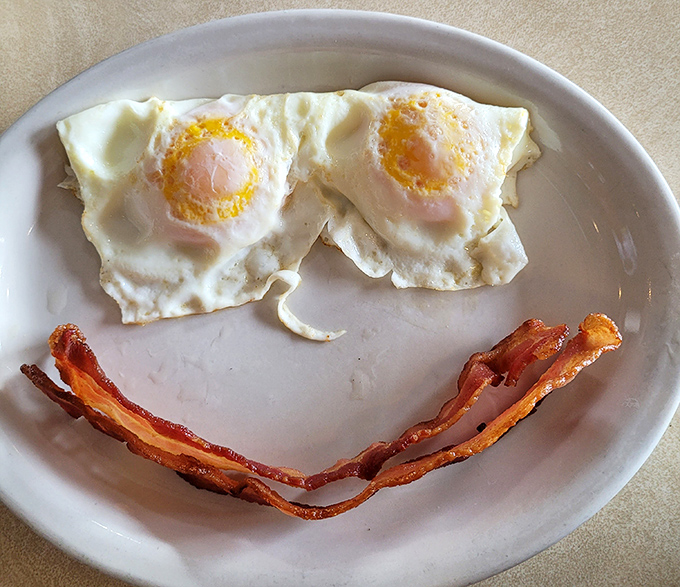 Breakfast's perfect couple &ndash; sunny-side up eggs and bacon arranged in a smile that knows exactly what you need.