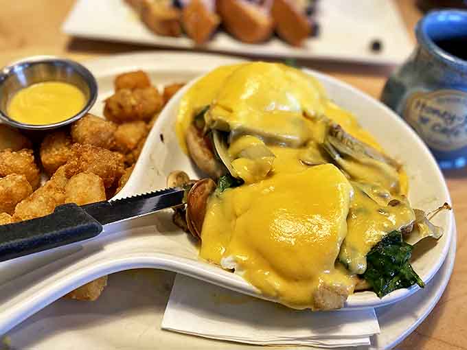 Eggs Benedict With Tater Tots: Breakfast architecture at its finest – golden tots standing at attention, ready to soak up every drop of precious hollandaise.
